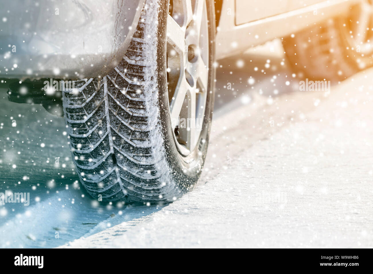Close-up of car wheels rubber tires in deep winter snow. Transportation ...
