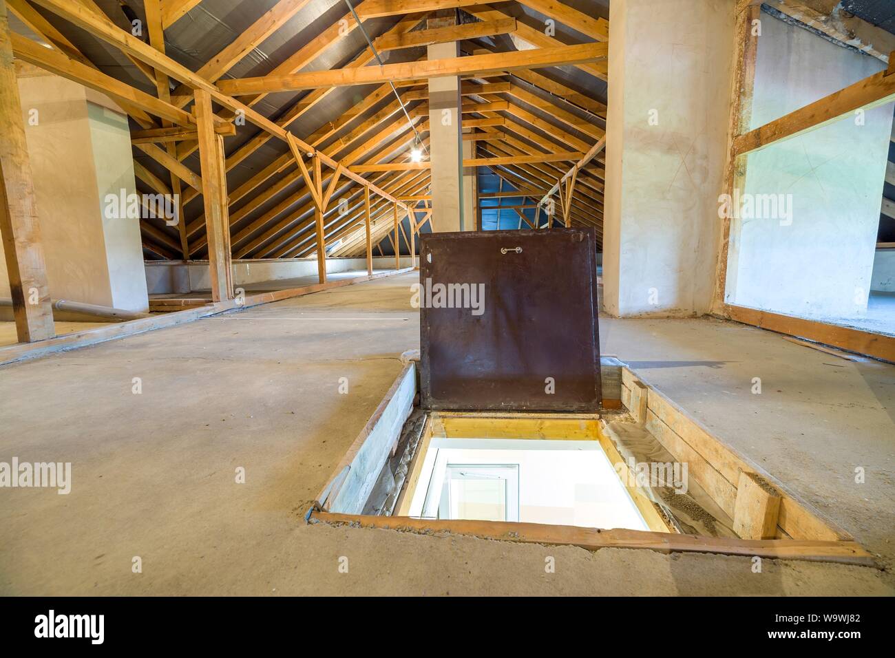 Attic of a building with wooden beams of a roof structure and a fire ...