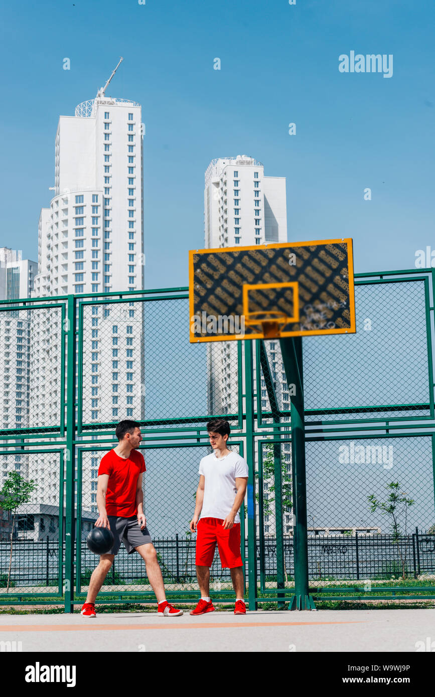 Basketball players playing ball(pushing, dribbling) on an urban ...