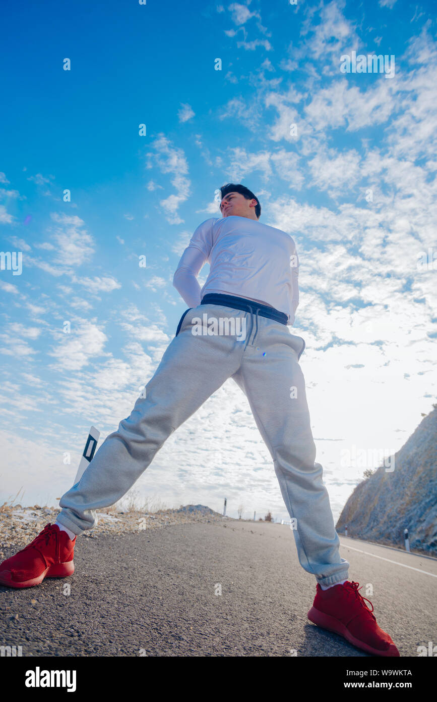 Fit male stretching and performing his morning routines while wearing a ...