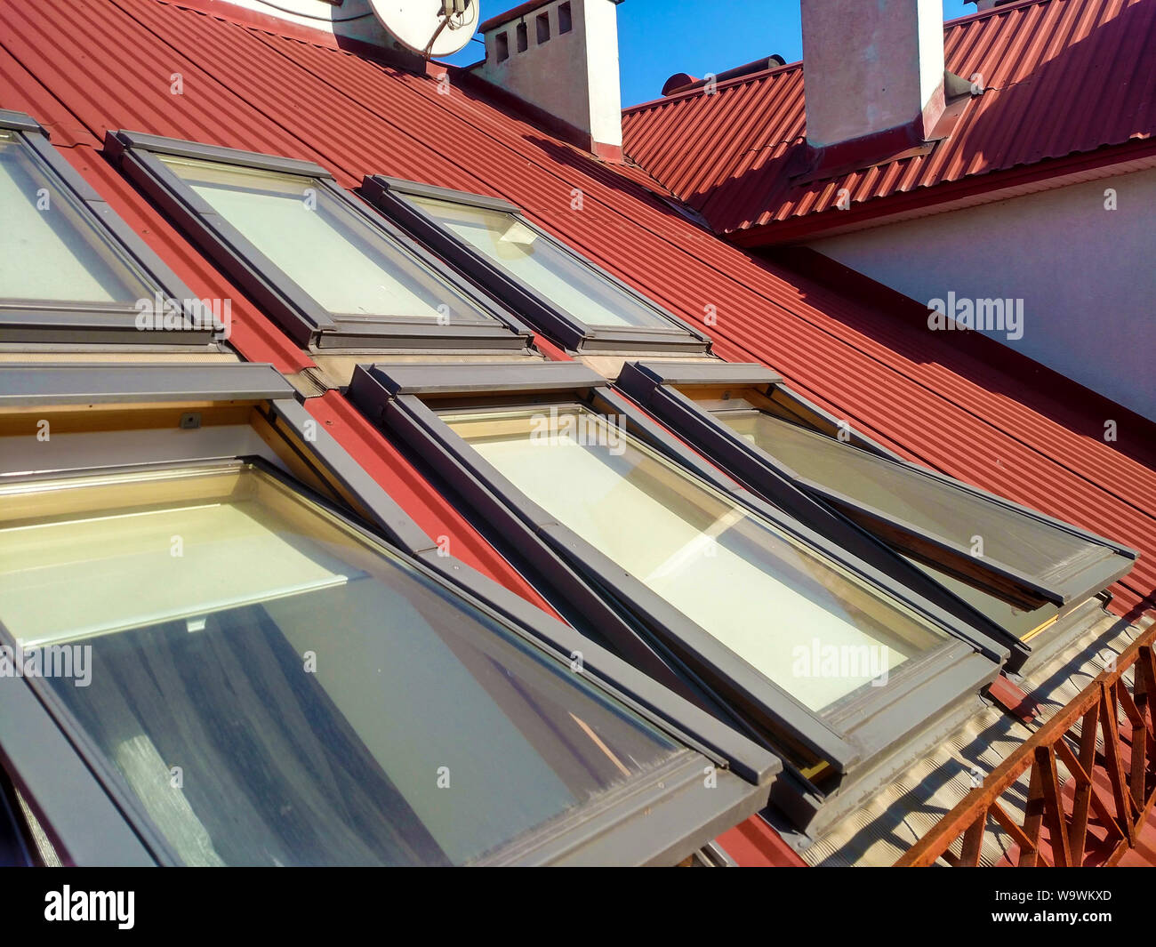 Red tiled house roof with attic windows. Roofing construction, window ...