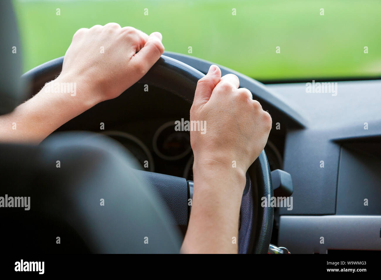 Woman hands on steering wheel driving a car Stock Photo - Alamy