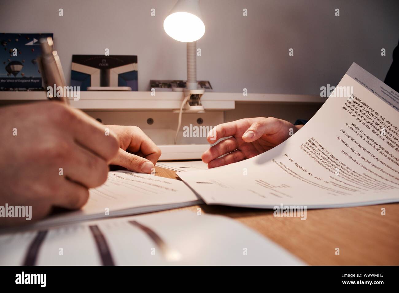Closeup shot of people's hands at a meeting with one person signing ...