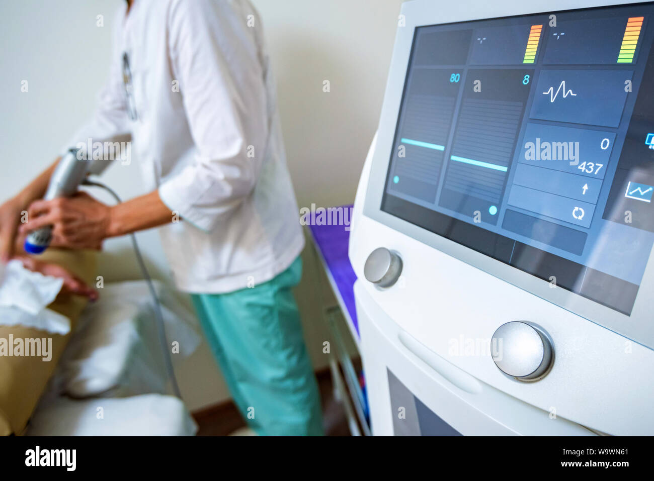 View of doctor using radial shockwave therapy machine in beauty parlor ...