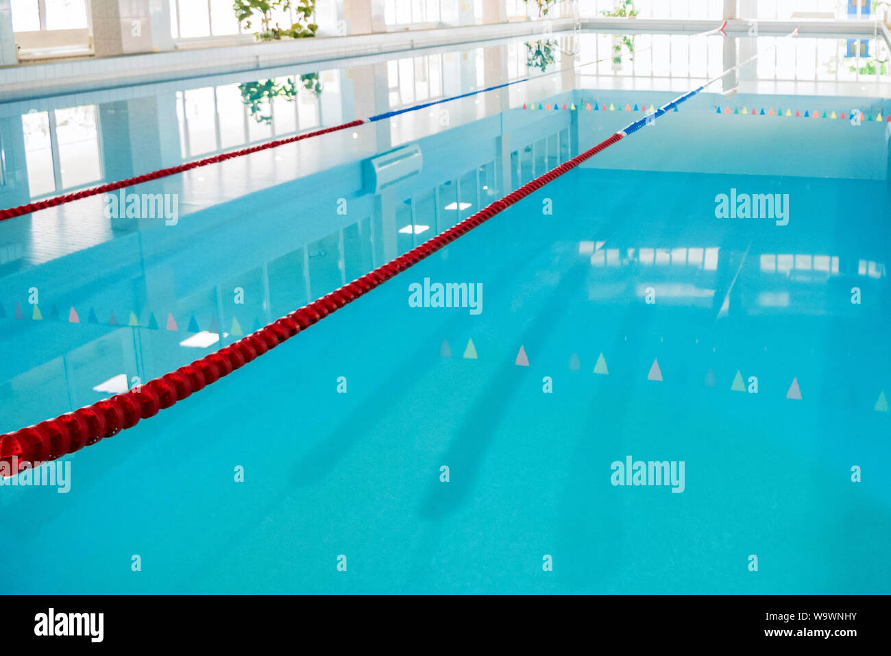 View of indoors swimming pool lanes with clean water Stock Photo - Alamy