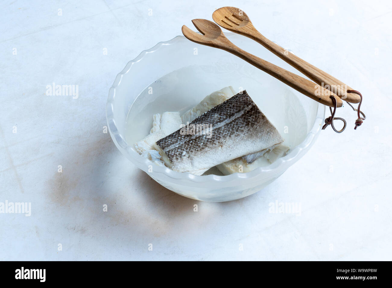 Salted and dried cod fish (Gadus morhua) in plastic bowl filled with ...