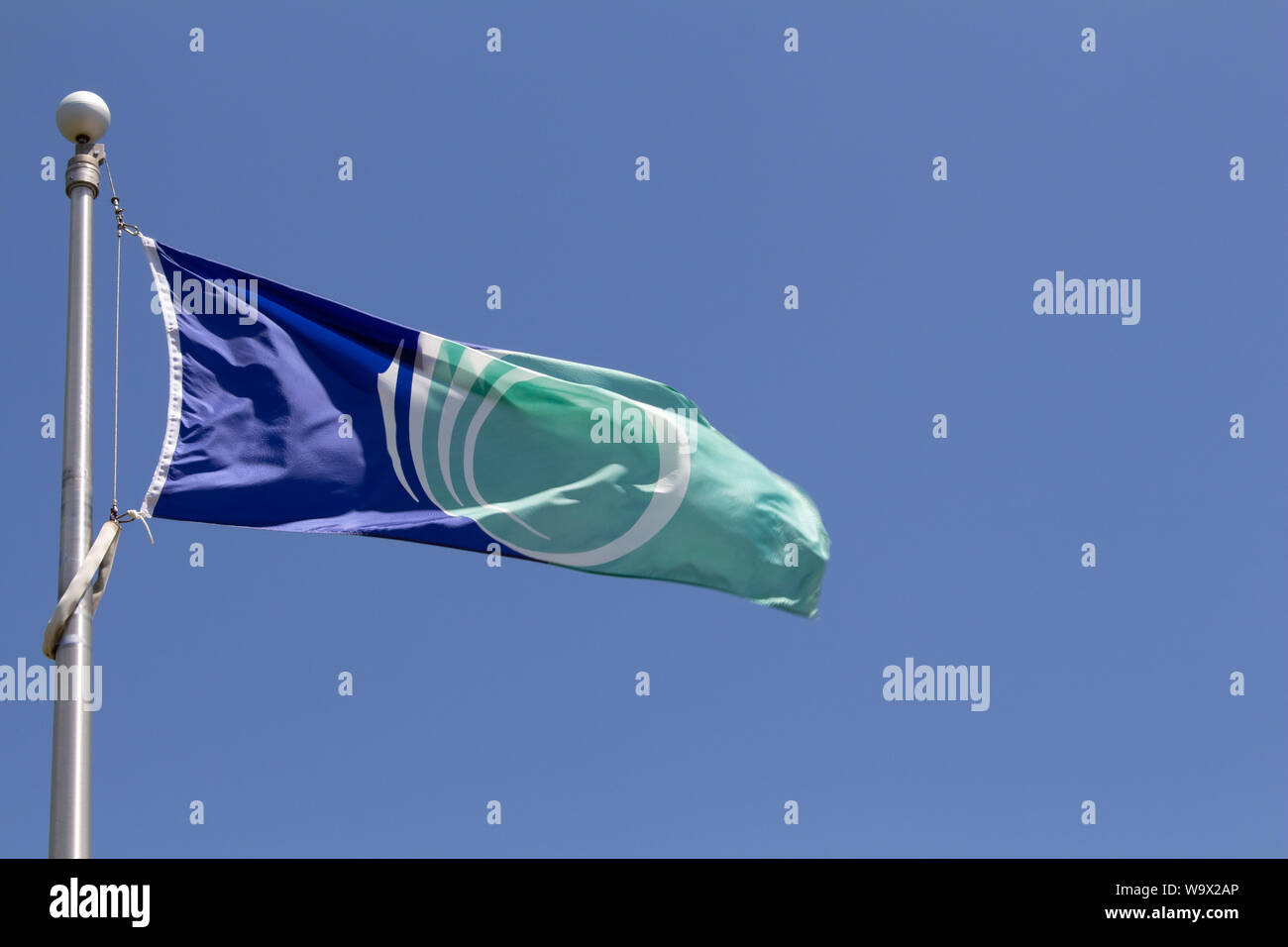 The flag of the City of Ottawa flies on a flagpole in the wind against ...