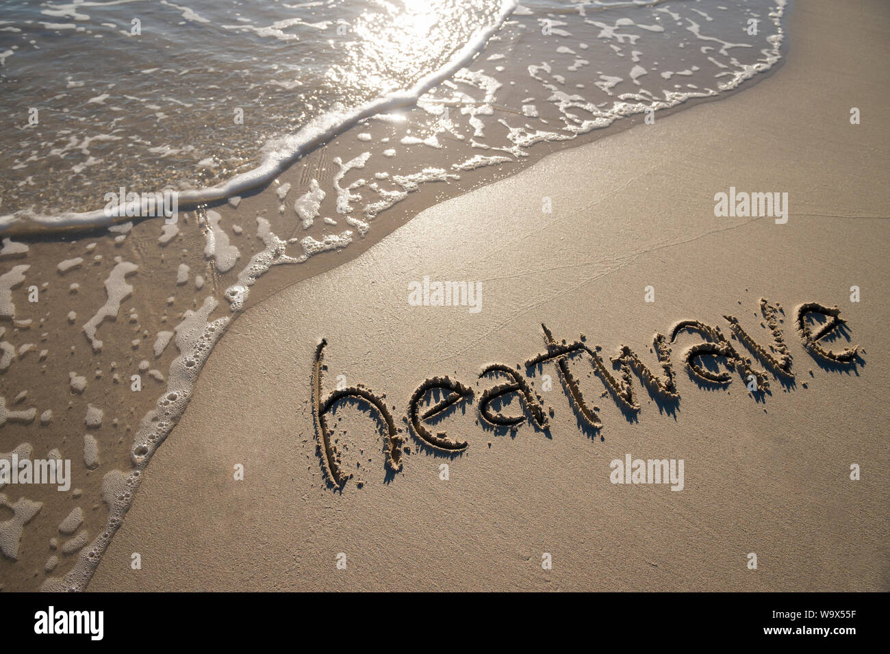 Message for summer beach weather, heatwave, written in smooth sand with ...