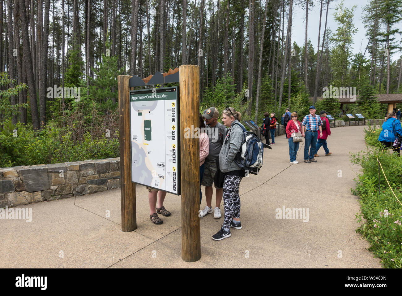 Tourists looking on the map at the Apgar Visitor Center in Glacier ...