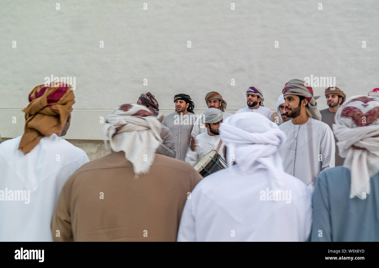 Emirati (Middle Eastern) Men performing a traditional dance in the ...