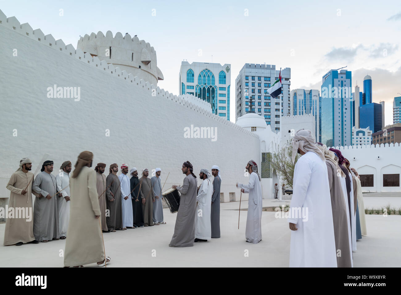 Emirati (Middle Eastern) Men performing a traditional dance in the ...