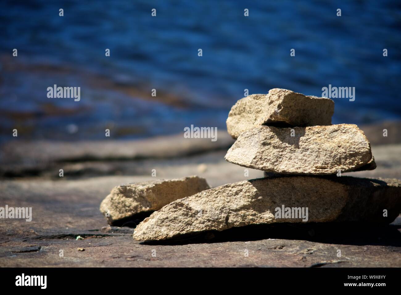 Stacked rocks on lake shore Stock Photo - Alamy