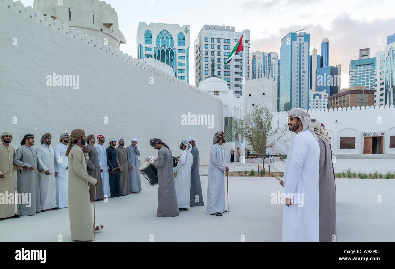 Emirati (Middle Eastern) Men performing a traditional dance in the ...