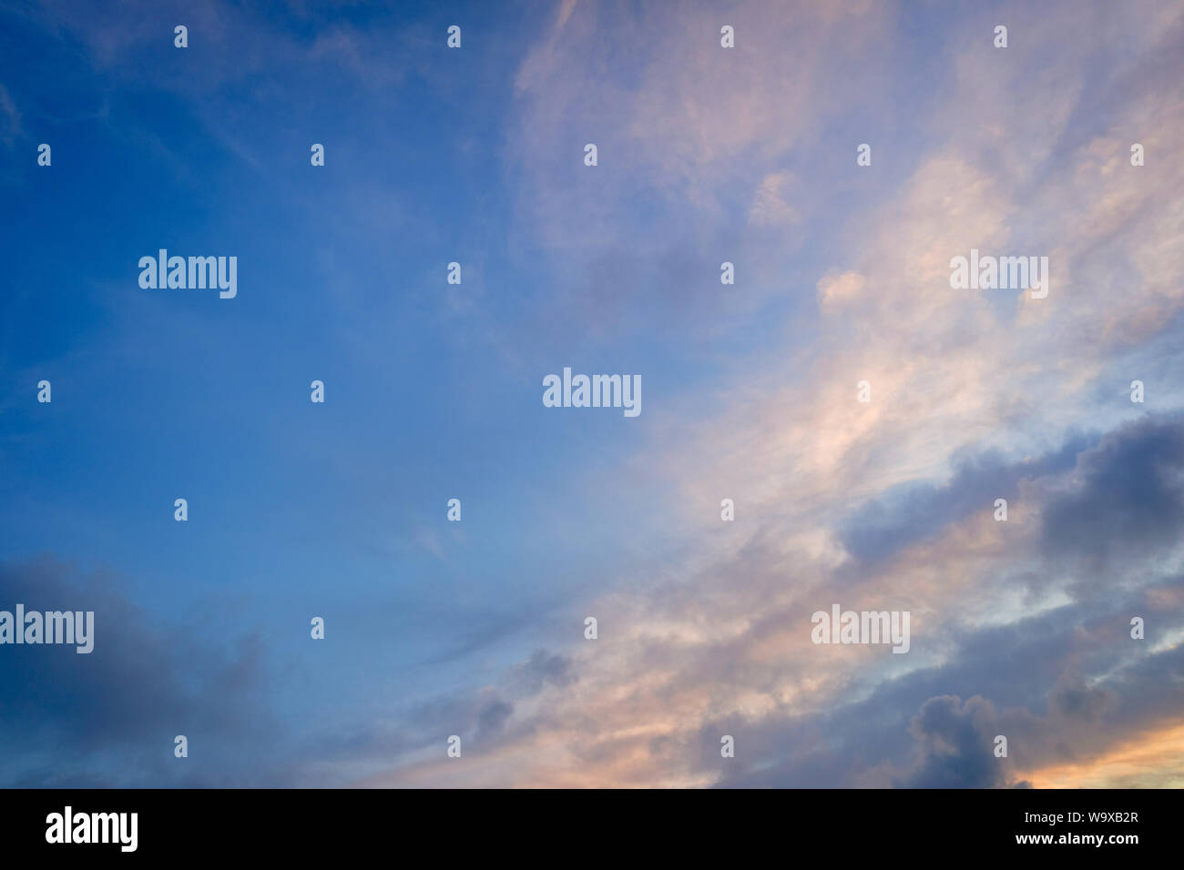 Autumn sunset sky background with warm colored clouds Stock Photo - Alamy