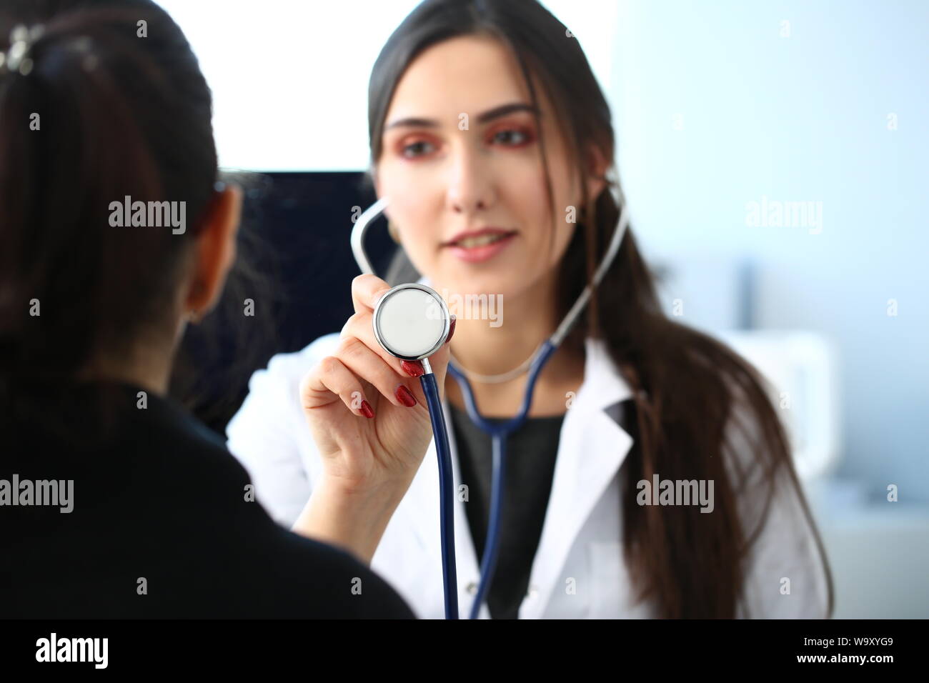 Beautiful smiling female doctor hold in arm Stock Photo - Alamy