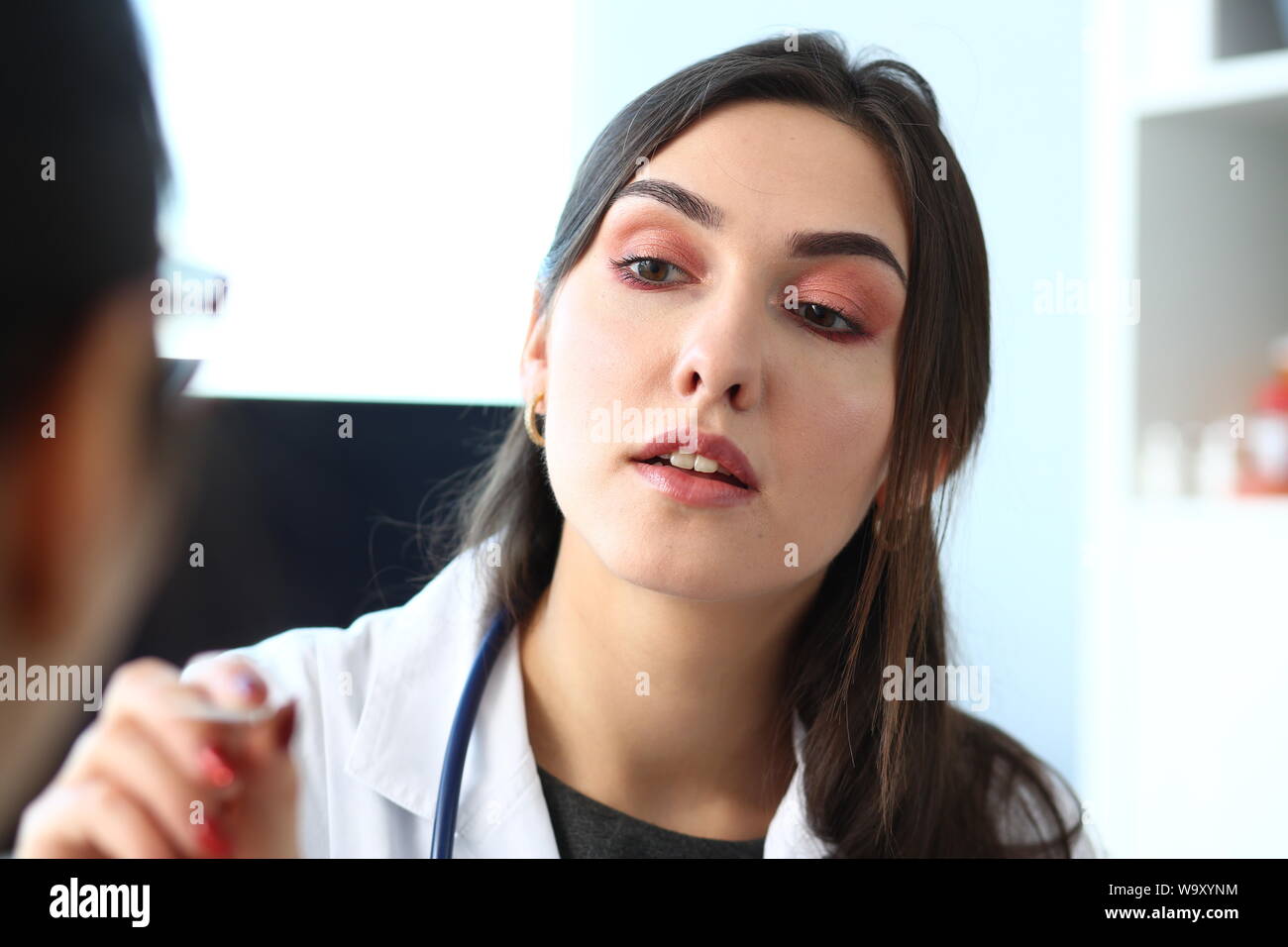 Beautiful smiling female doctor talk with patient Stock Photo - Alamy