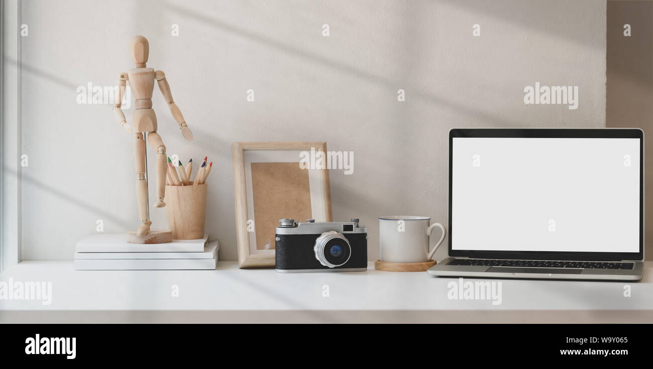 Photographer creative studio with blank screen laptop and office ...