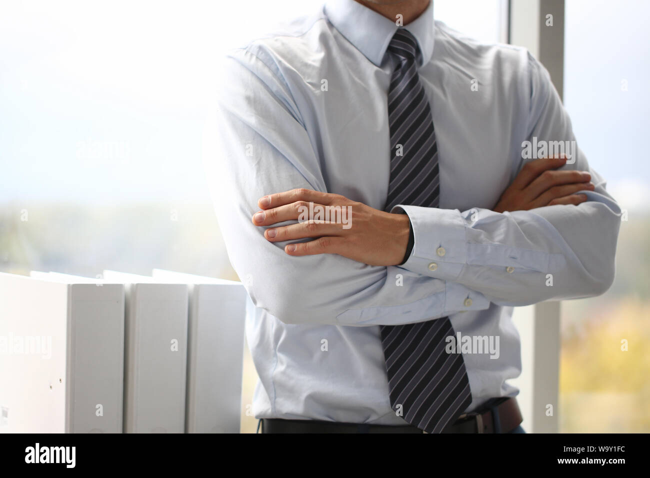 Male hands in suit crossed on chest closeup background Stock Photo - Alamy