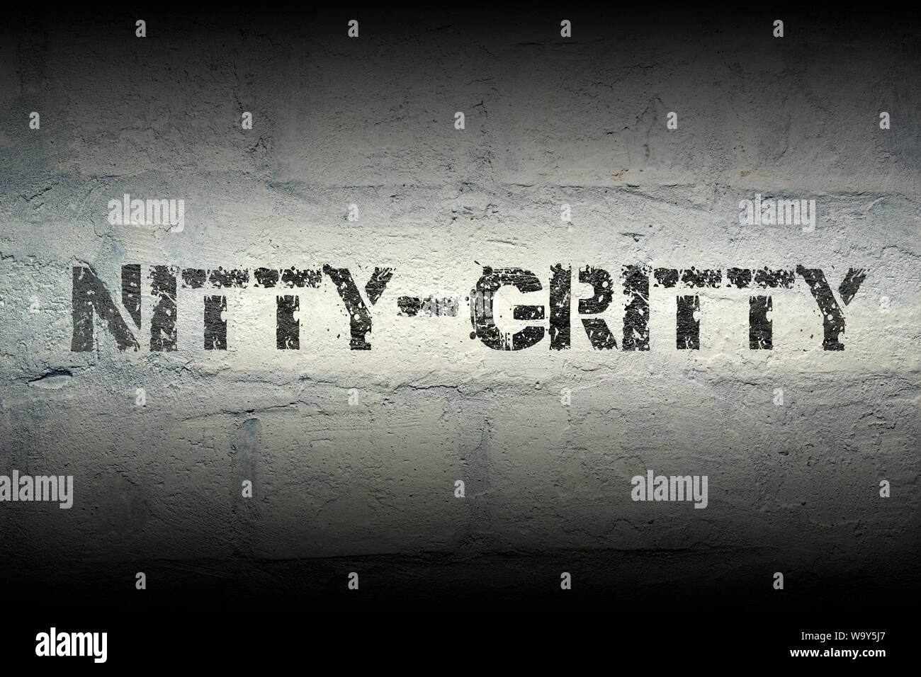 nitty-gritty stencil print on the grunge white brick wall Stock Photo ...