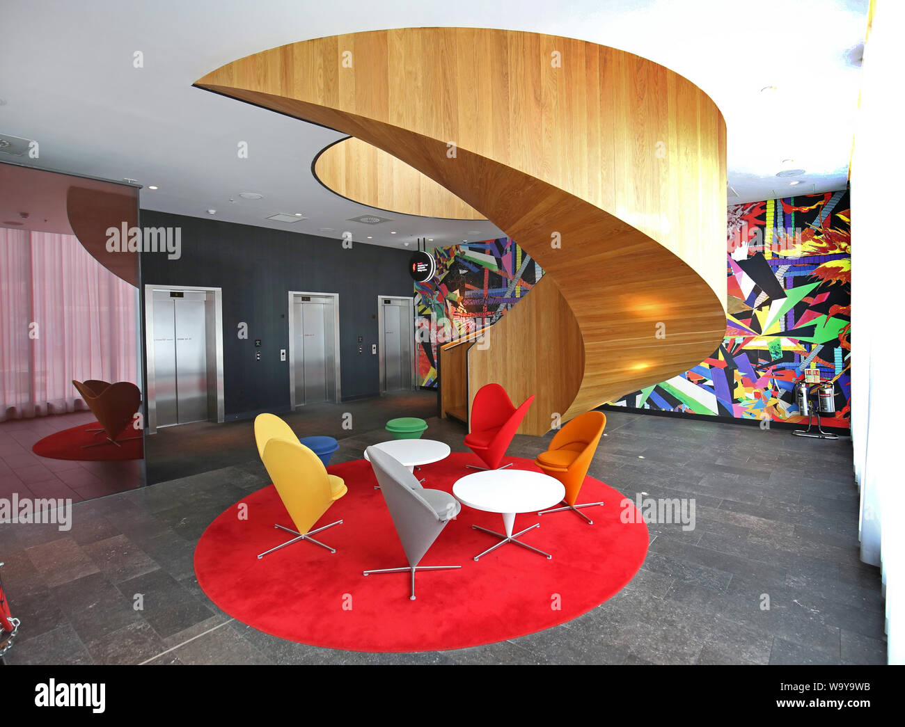 Circular, timber staircase in the ground floor entrance lobby to the ...