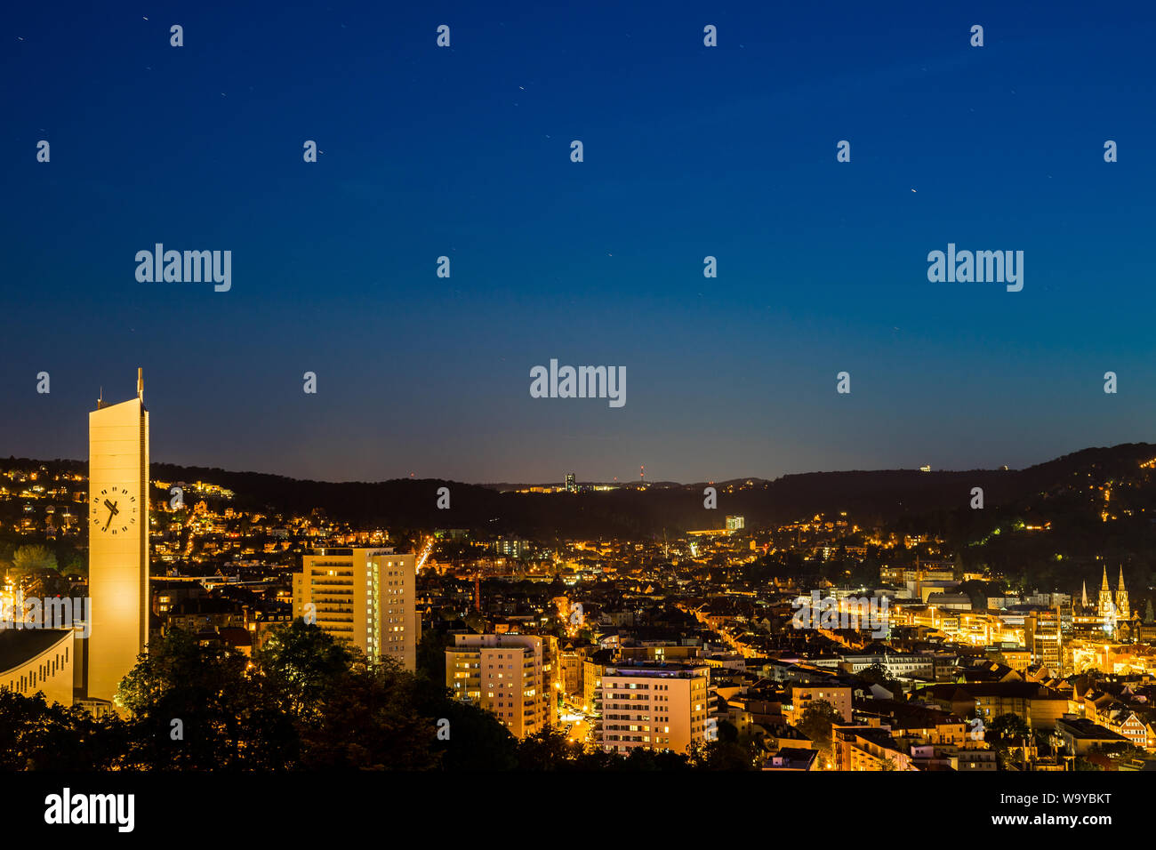 Germany, Stuttgart, Starry sky full of stars over skyline of houses of ...