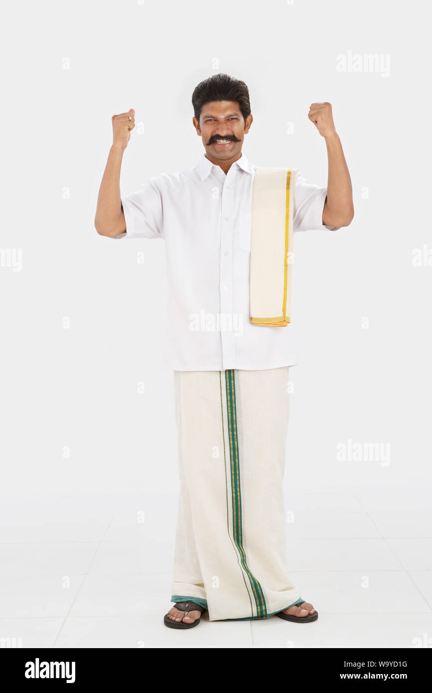 South Indian man smiling with his arm outstretched Stock Photo - Alamy