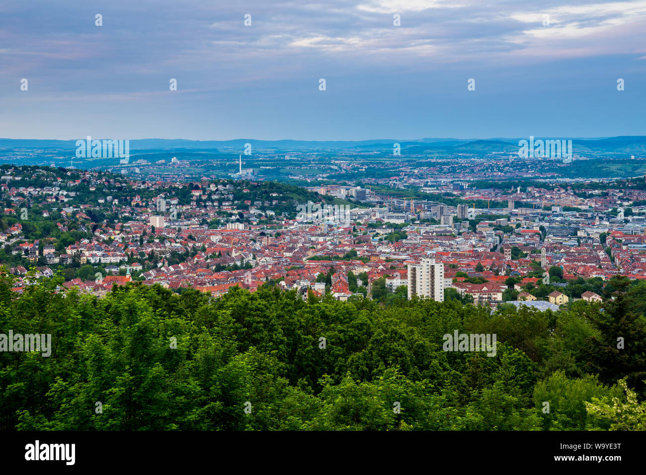 Germany, Houses of city stuttgart in valley surrounded by many hills ...
