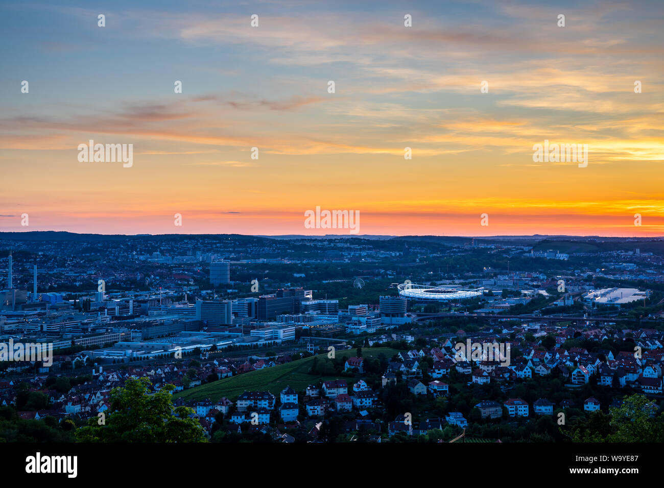 Germany, Red sky over houses of major city stuttgart downtown skyline ...