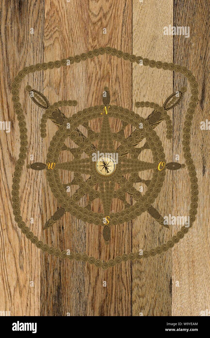 Compass anchor wheel from old ropes on wood Stock Photo - Alamy