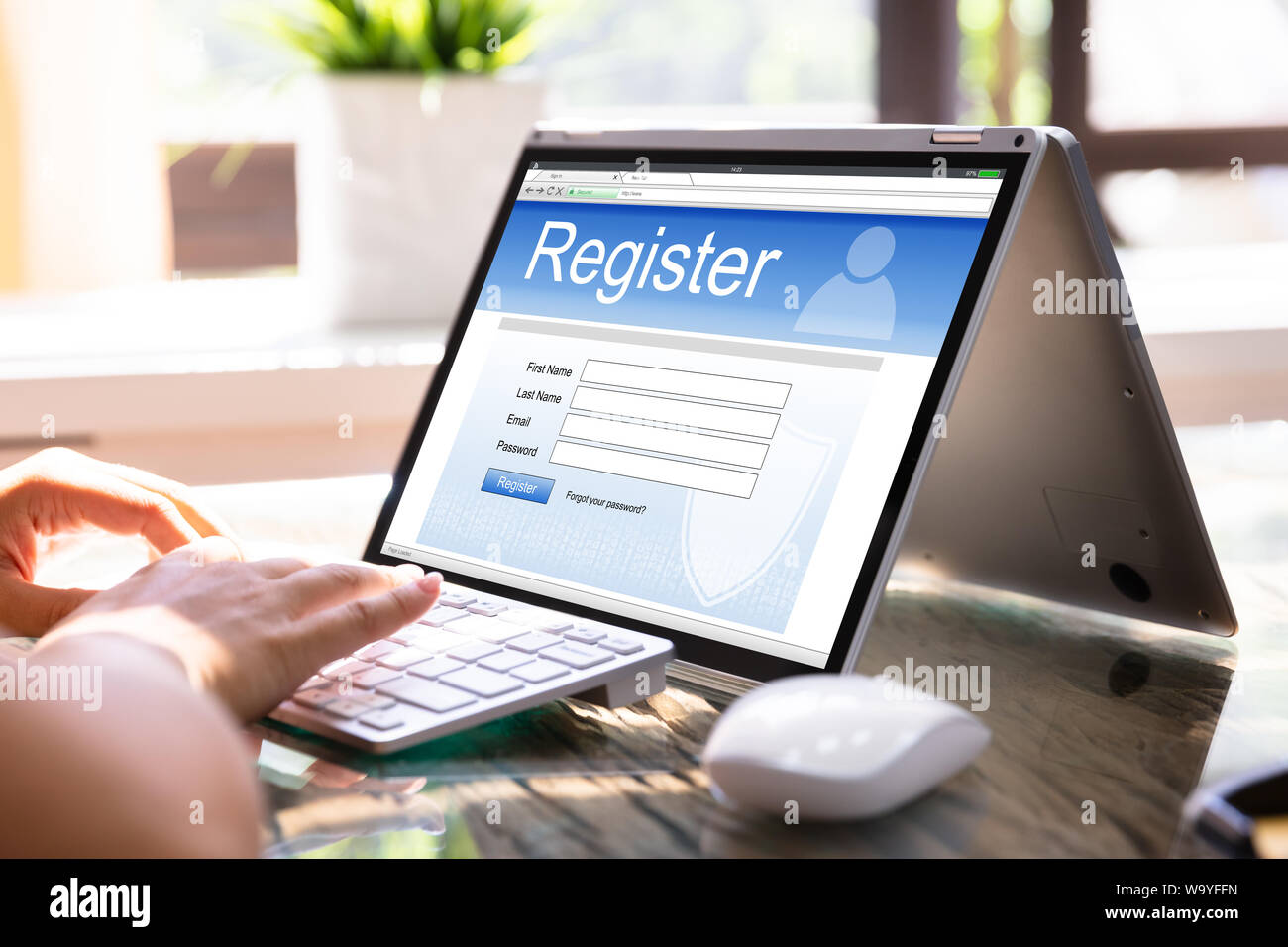 Woman Filing Online Registration Form On Laptop Stock Photo - Alamy