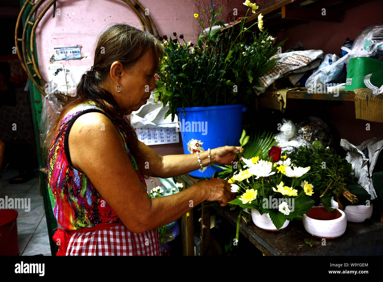 ANTIPOLO CITY, PHILIPPINES – AUGUST 12, 2019: A flower shop owner ...