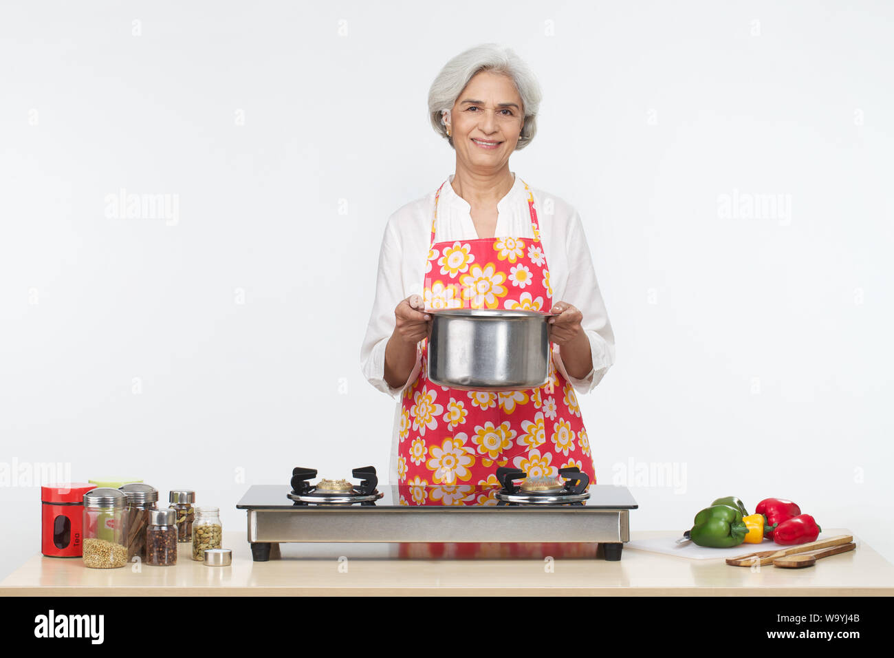 Senior woman cooking food in kitchen Stock Photo - Alamy