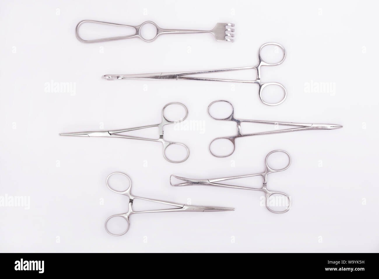 Metal surgical instruments on white background. Plastic surgical ...