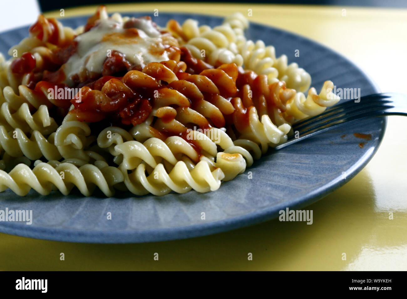 Photo of freshly cooked spiral pasta with cheese and tomato sauce Stock ...
