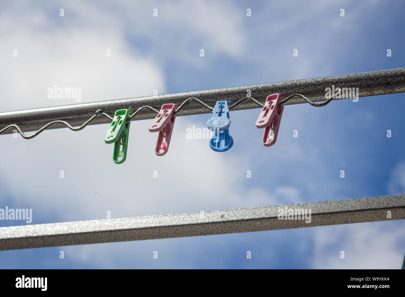 Plastic clothespin on a clothesline and in the daytime sky Stock Photo ...