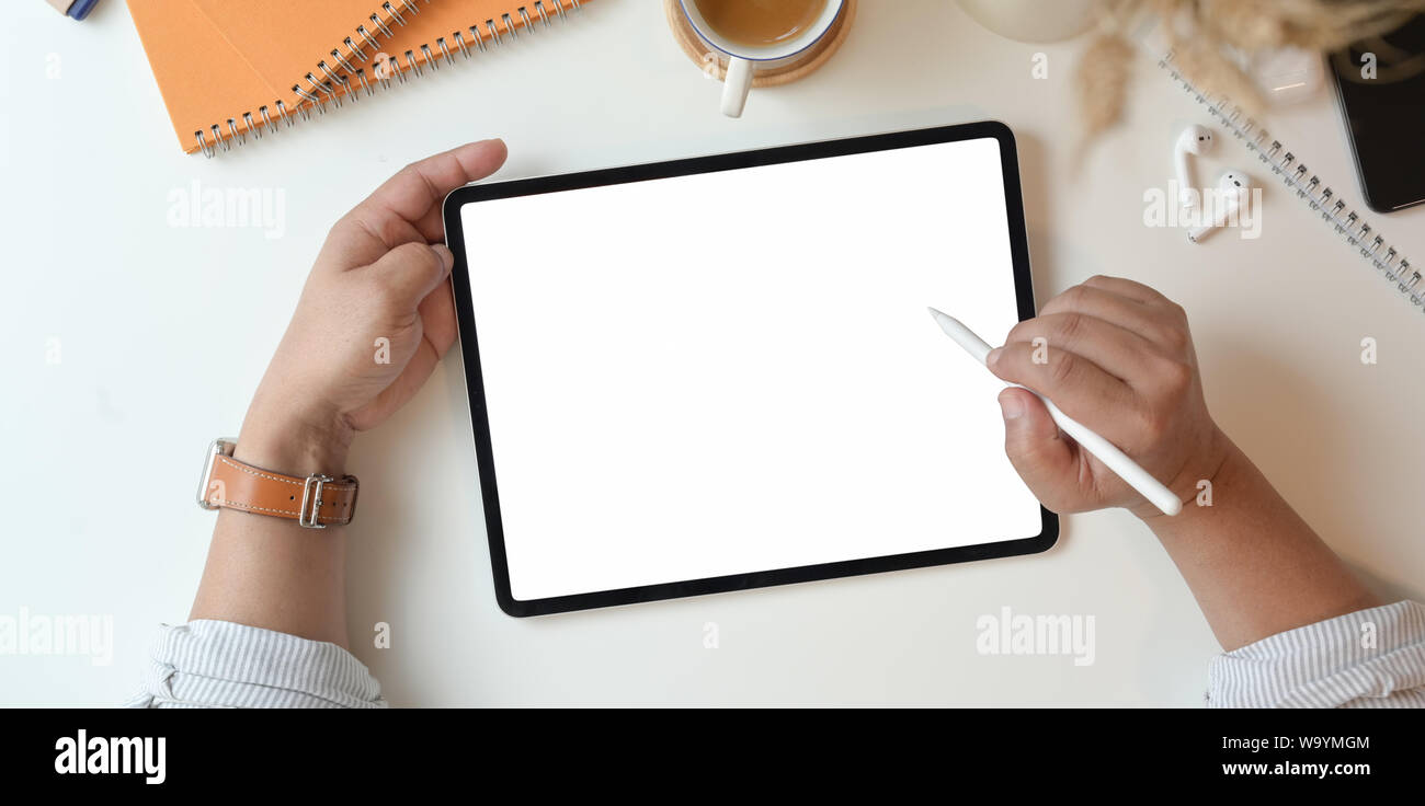 Professional photographer drawing on blank screen tablet in comfortable ...