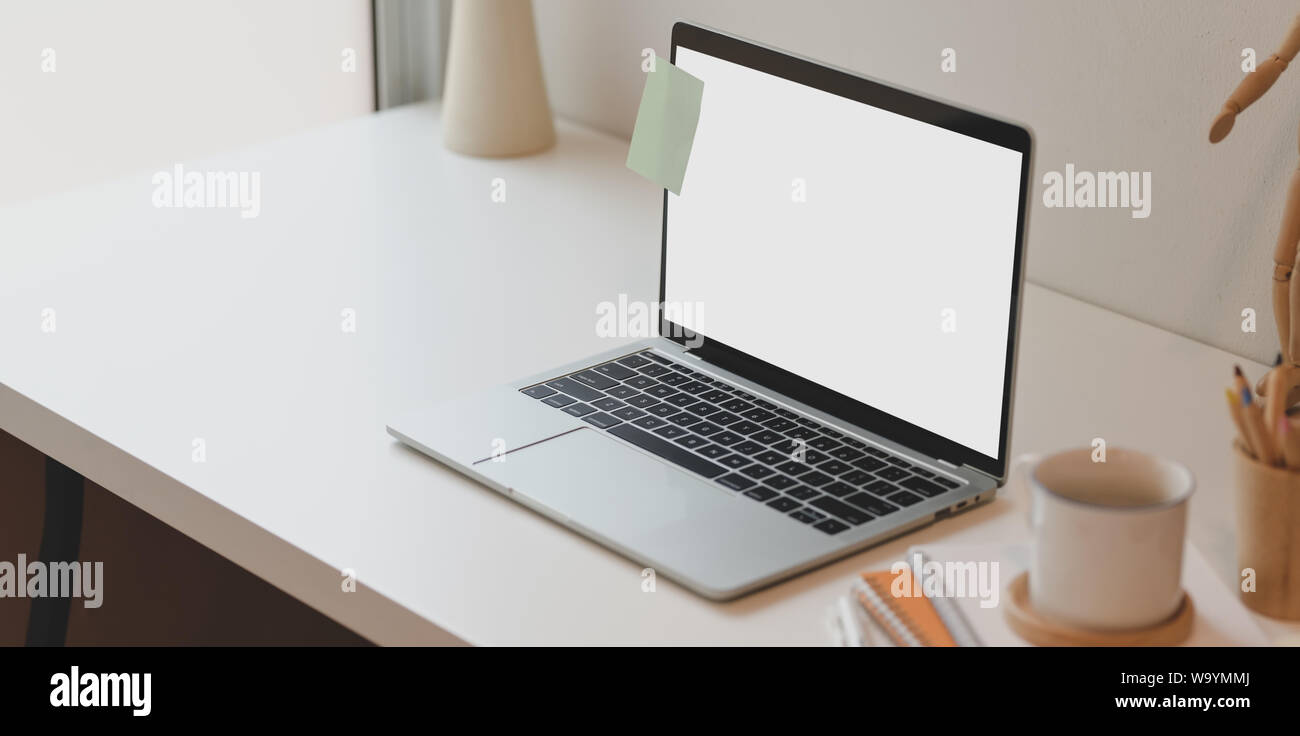 Minimal comfortable room with open blank screen laptop and office ...