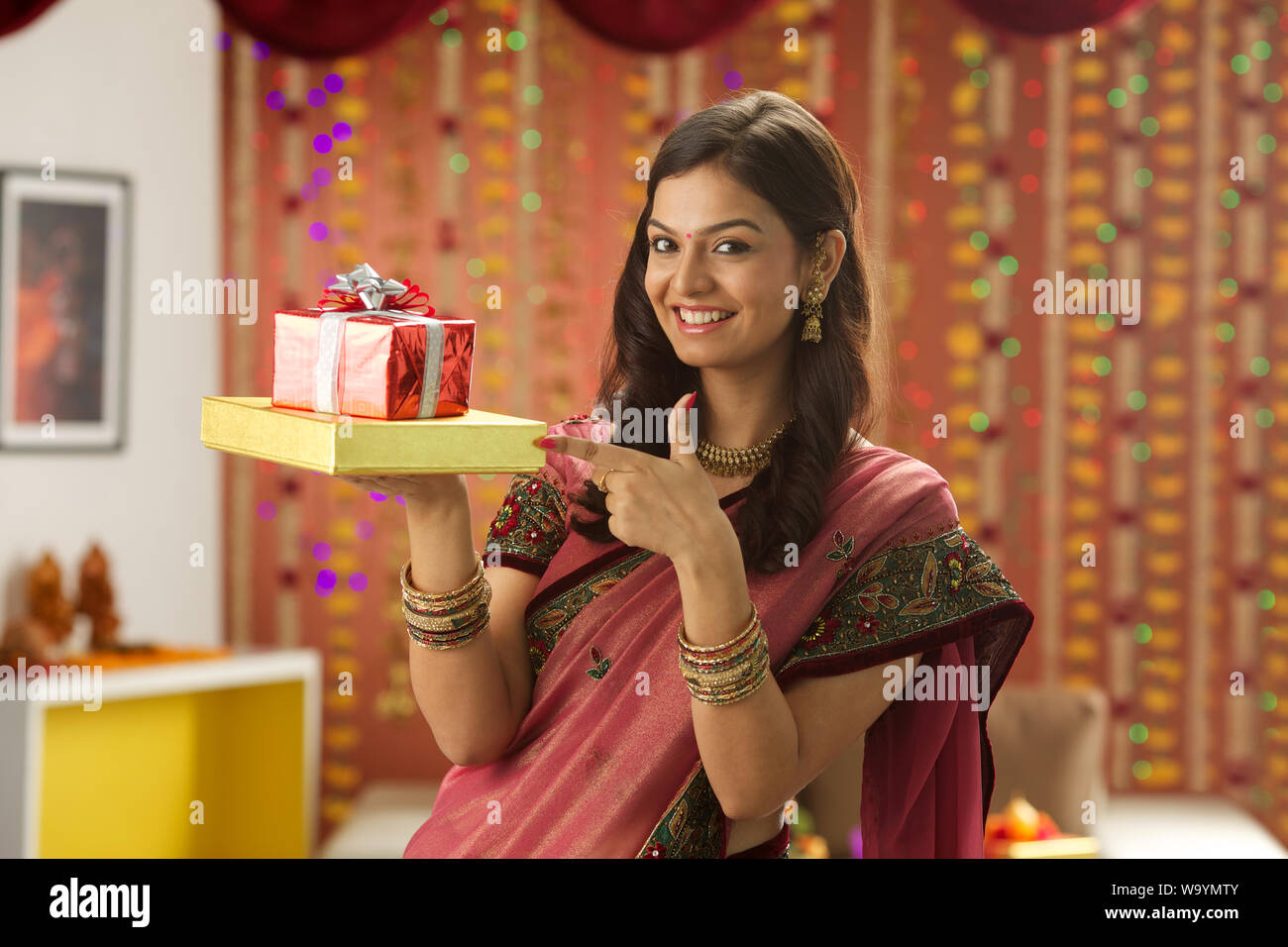 Young woman holding gift boxes Stock Photo - Alamy