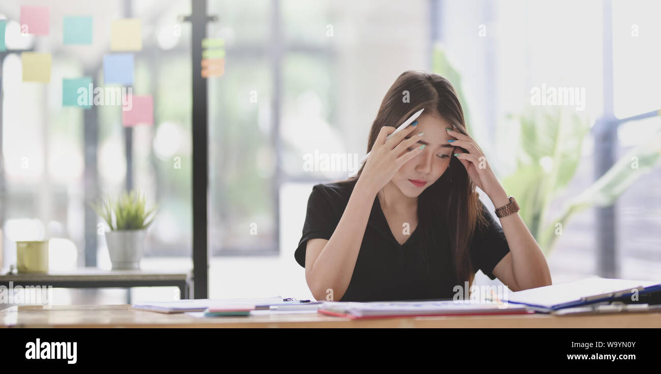 Sad female designer sitting on hi-res stock photography and images - Alamy