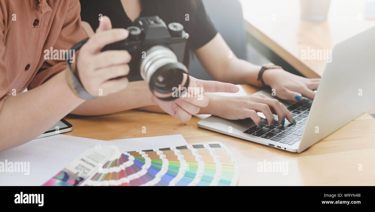 Close-up view of graphic designer team discussing the project together ...