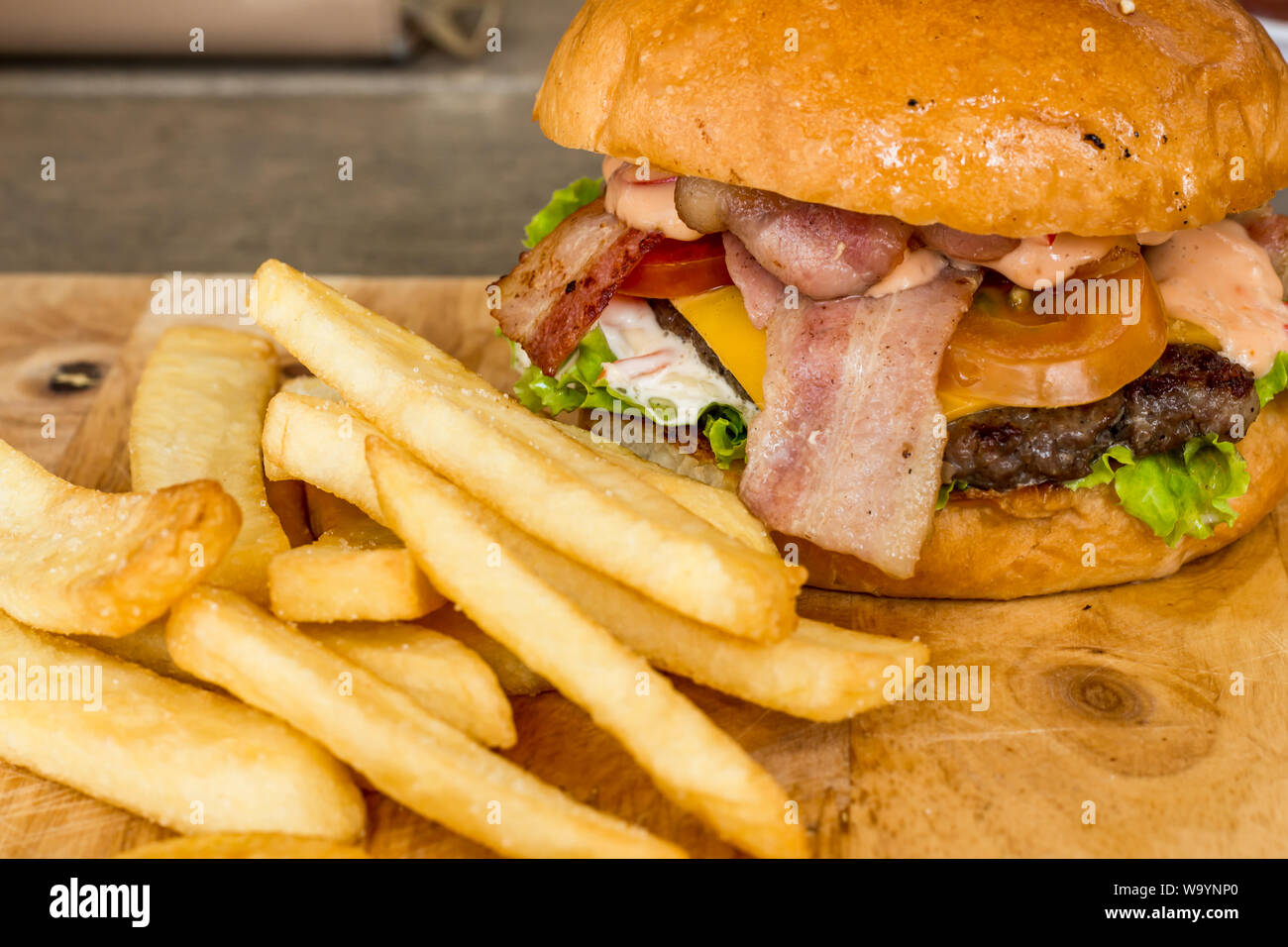 Hamburger with pork, beef, and vegetables is in the bread, overlapping ...