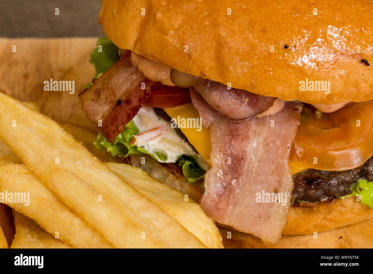 Hamburger with pork, beef, and vegetables is in the bread, overlapping ...