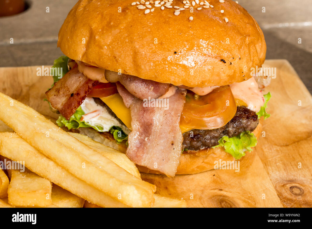 Hamburger with pork, beef, and vegetables is in the bread, overlapping ...