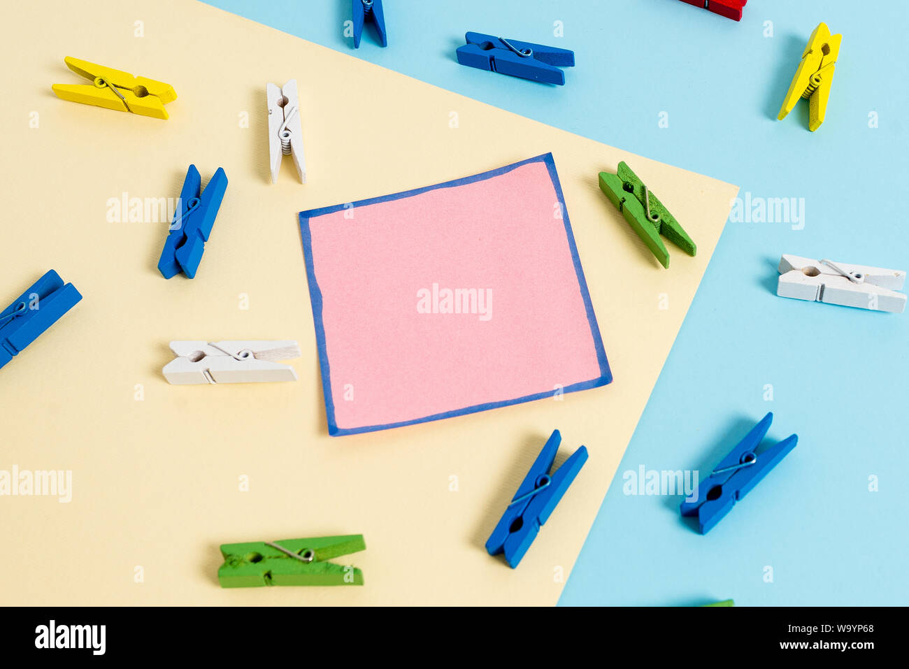 Colored clothespin paper empty reminder yellow blue floor background ...