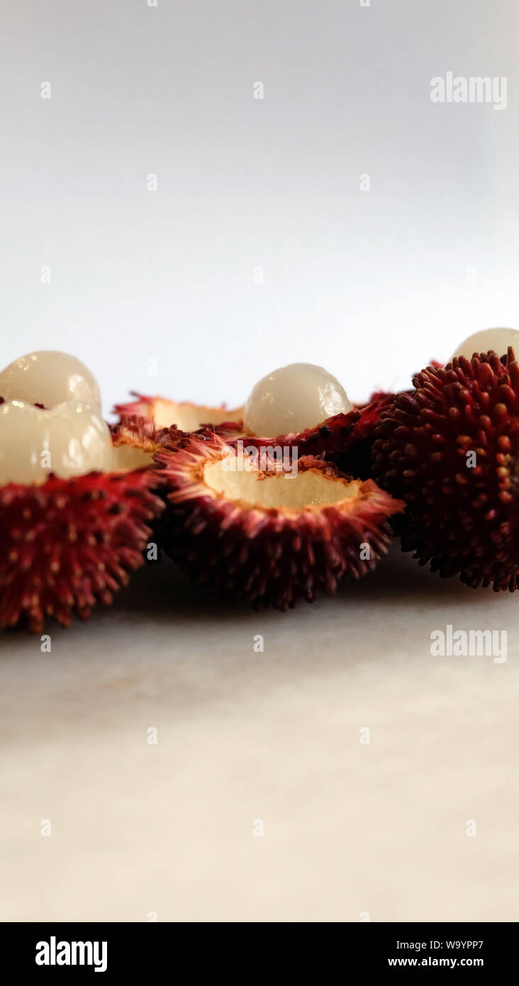 Peeled pulasan fruits in vertical photo. Scientific name Nephelium ...