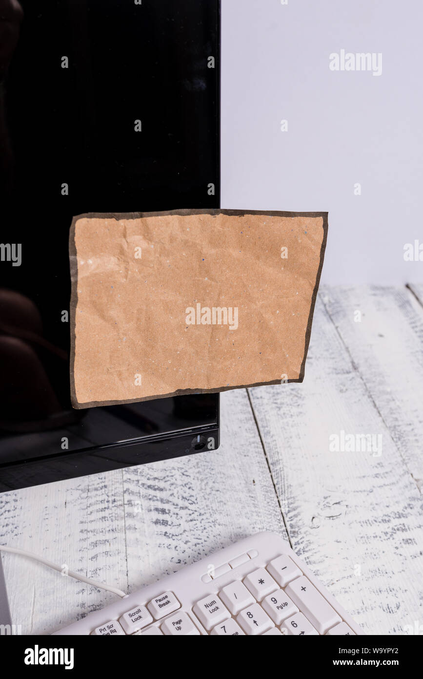 Notation paper taped to black computer monitor screen near white ...