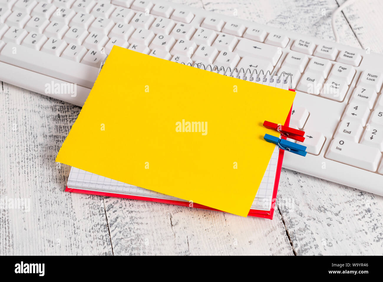 notebook paper reminder clothespin pinned sheet white keyboard light ...