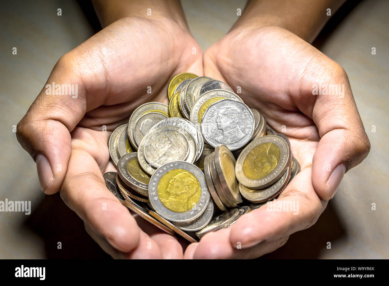 Hand held coin hi-res stock photography and images - Alamy