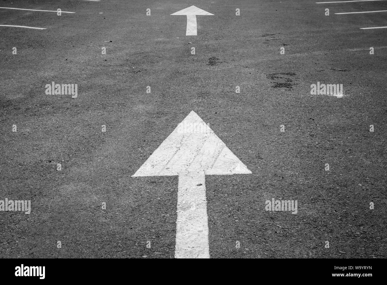 Arrow symbol traffic on the road asphalt. Sign of further progress ...