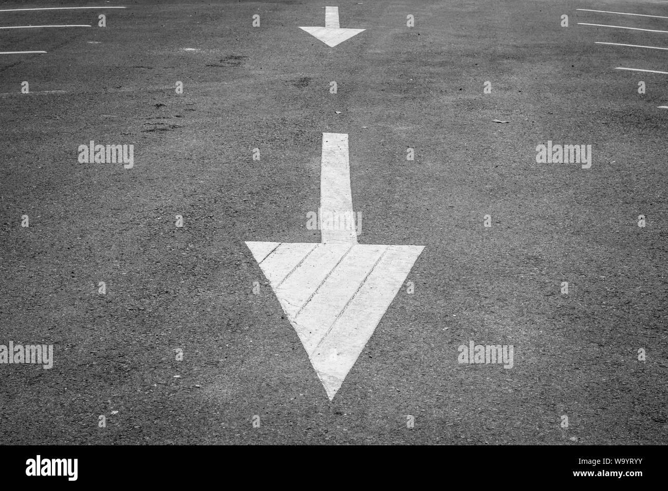 Arrow symbol traffic on the road asphalt. Sign of further progress ...